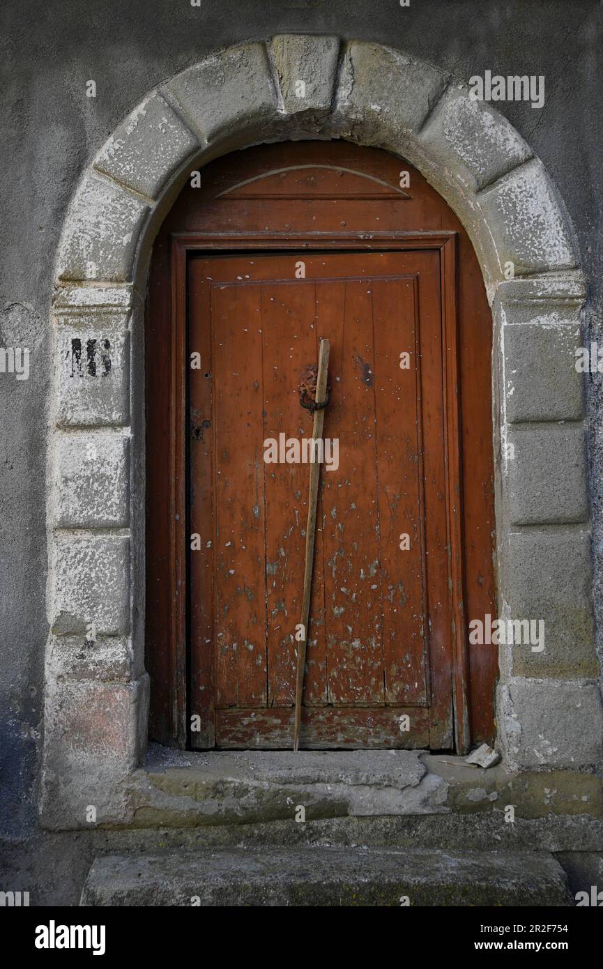 Antique stone arched wooden entrance door on Via Dejoannon in Forza d ...