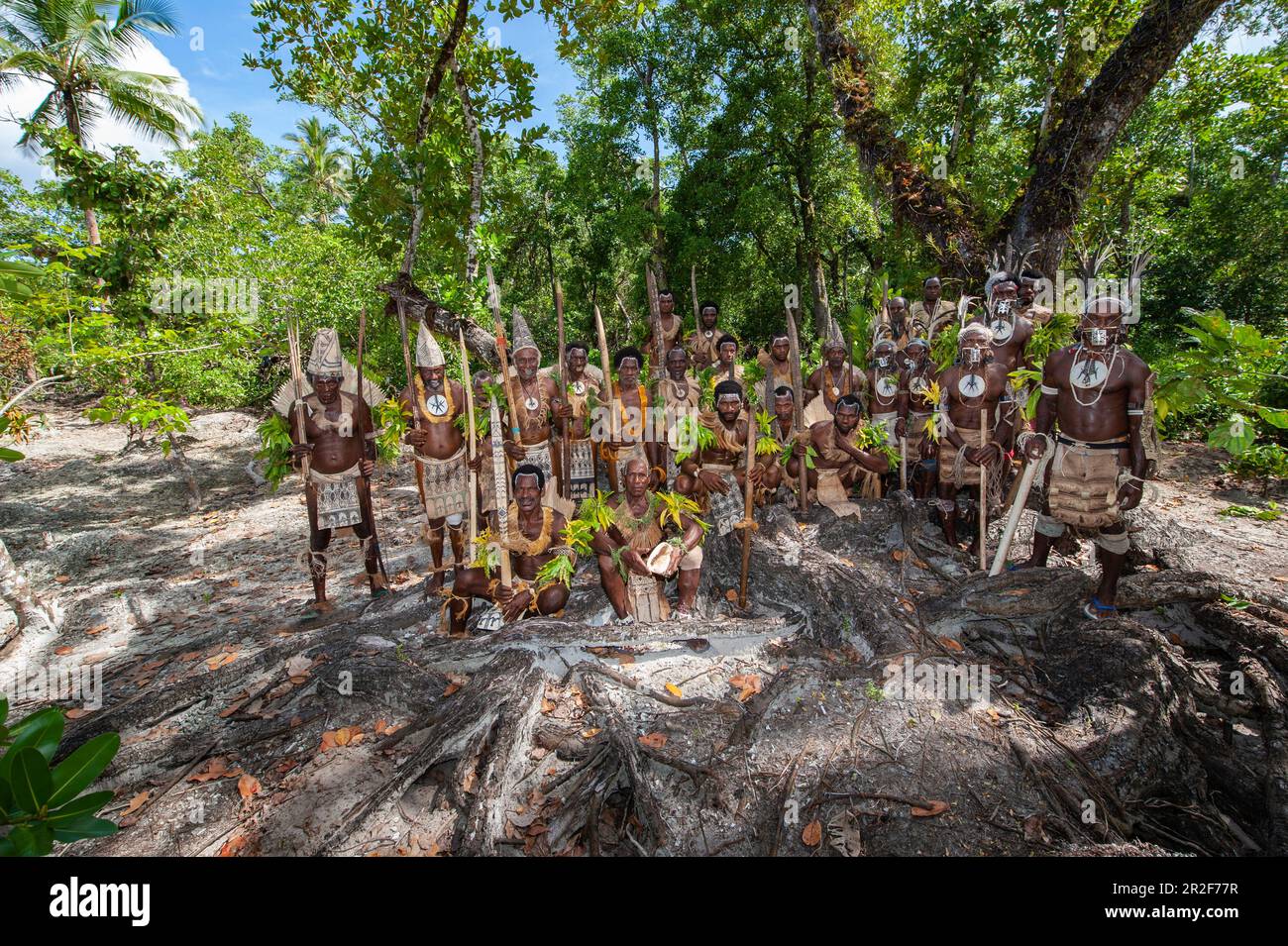 A group of people in traditional costume pauses from a folklore ...
