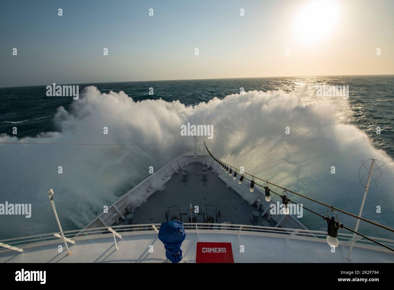 The front of an expedition cruise ship encounters a large wave and ...