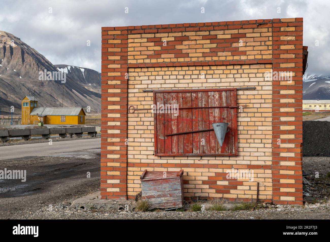 An unused building stands opposite the runway for the former mining ...