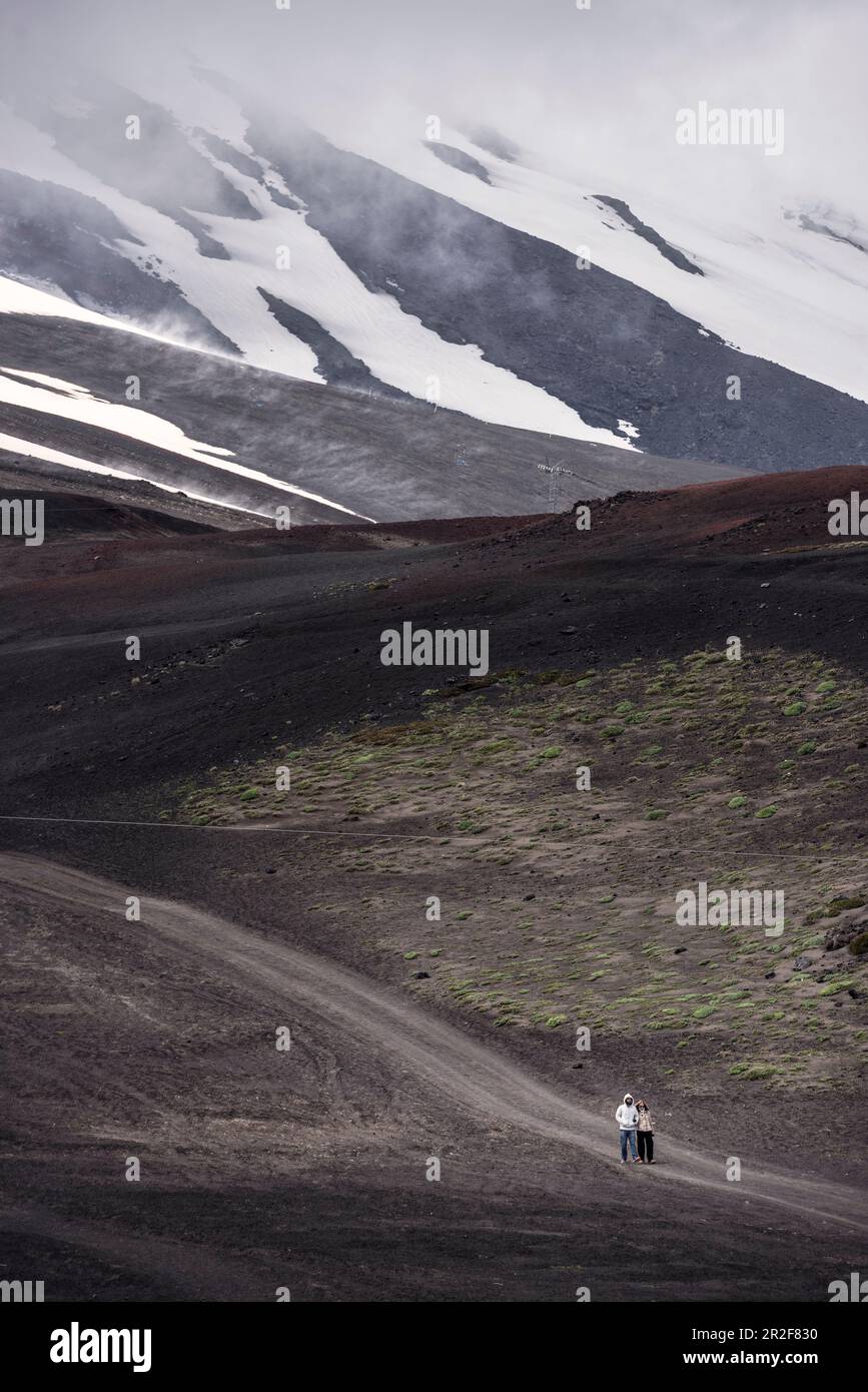 People walk on the volcanic ash of the Osorno volcano, Region de los ...