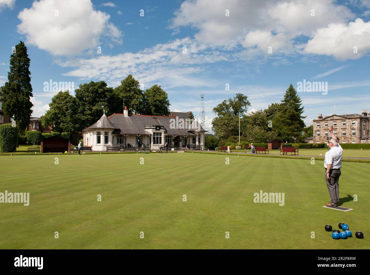 Men bowling in front of the pavilion of the Ardgowan lawn bowling Green ...