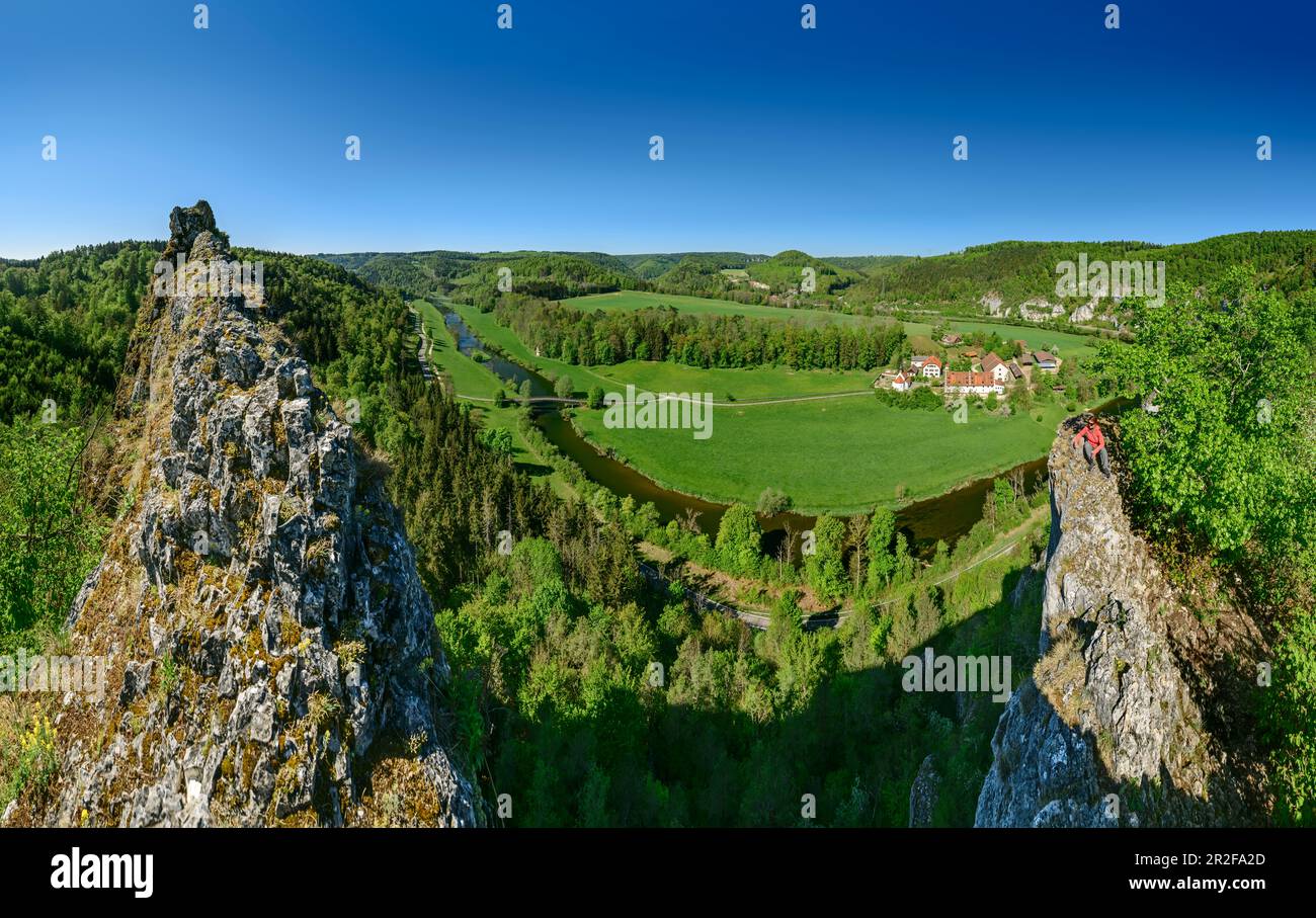 Panorama with woman sitting on rock tower, Danube in the background ...