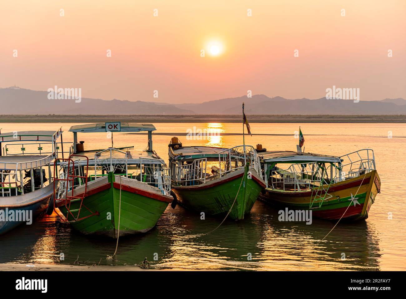Boats on the banks of the Irrawaddy River at sunset Bagan, Myanmar ...