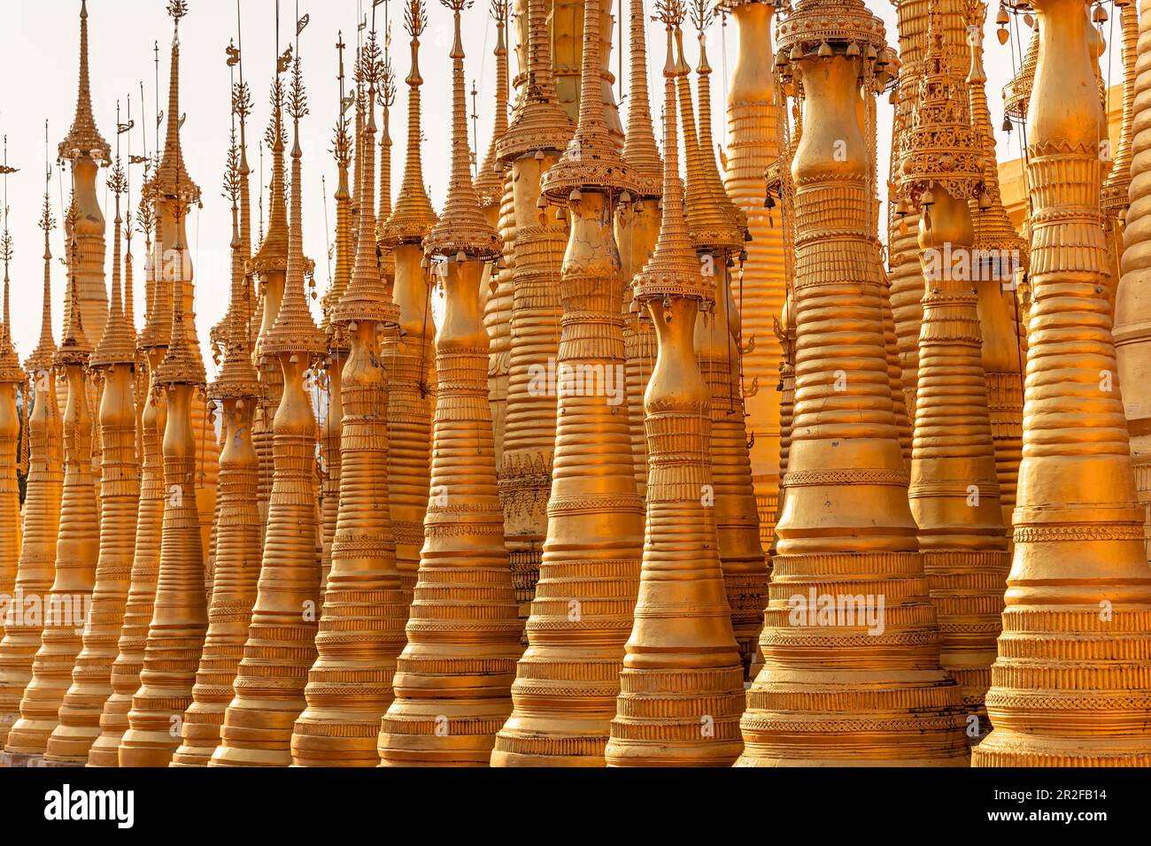 Shwe Inn Dein Pagoda - stupa field with golden stupas in the evening ...