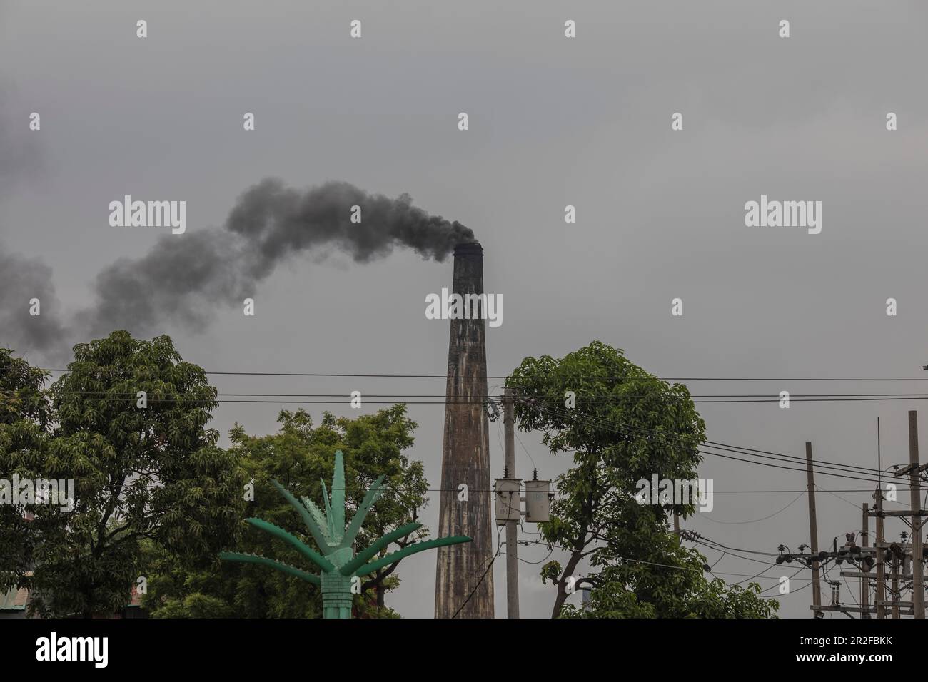 Dhaka, Bangladesh. 19th May, 2023. Smoke comes out from a kiln tower at ...