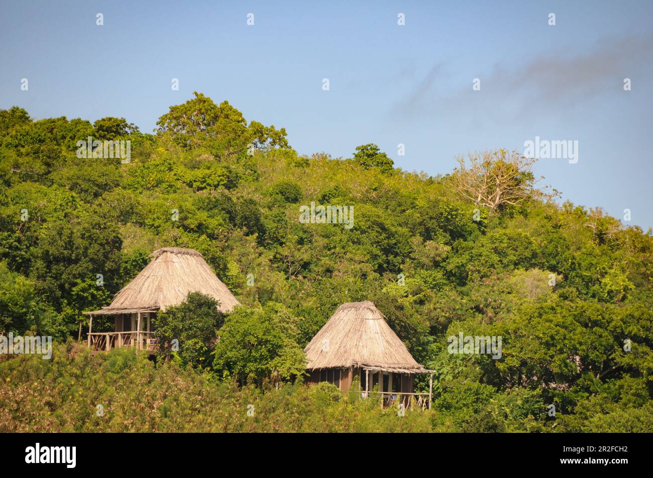 Small huts of a beach resort, surrounded by tropical vegetation, Fiji ...