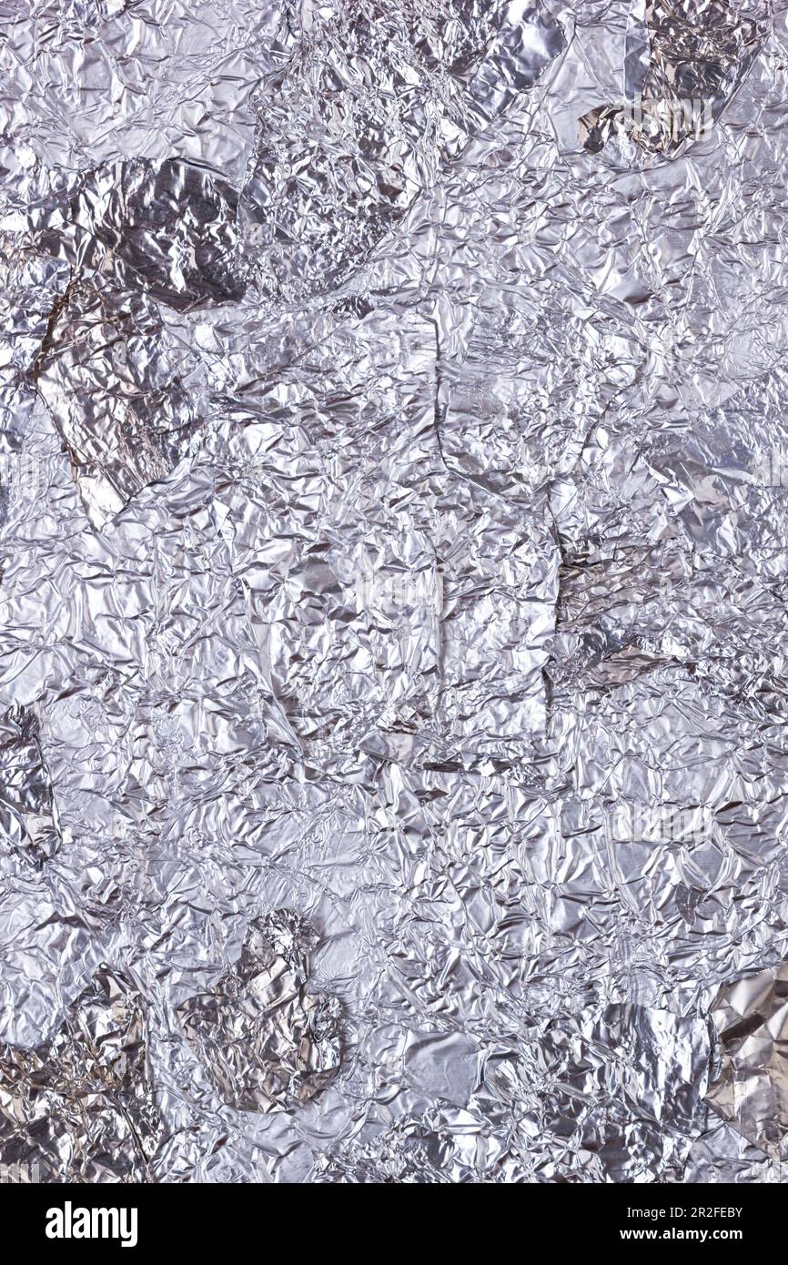 Shiny heavily wrinkled metal silver gray foil vertical texture ...