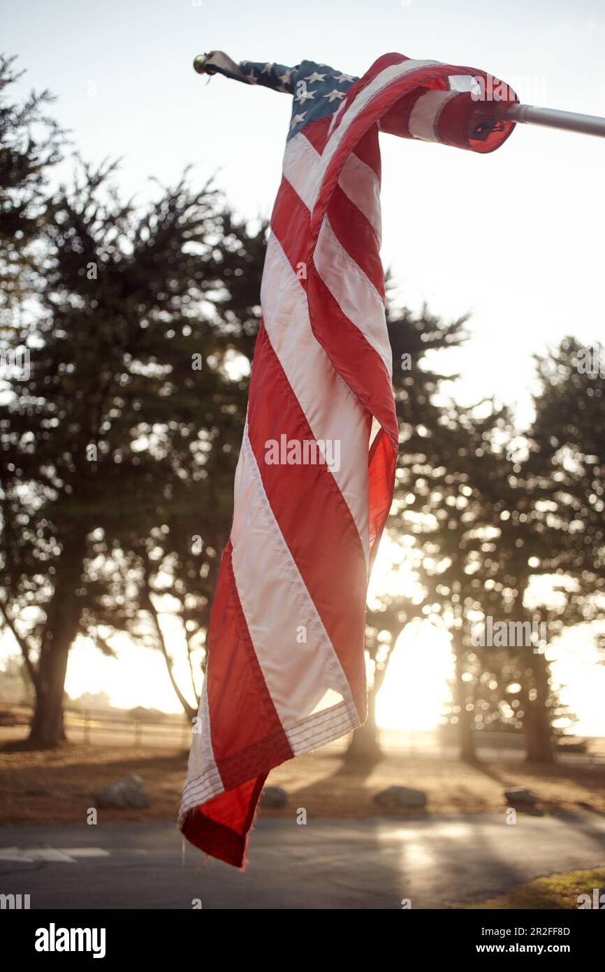 Tangled American flag in the evening light in a parking lot at Big Sur ...