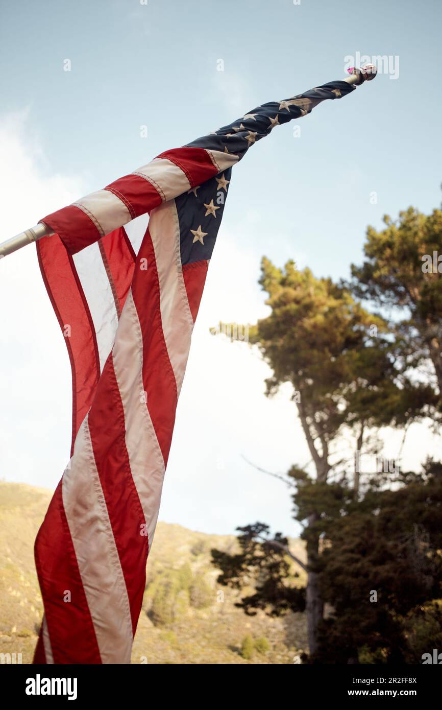 American flag in the evening light in a parking lot near Big Sur on ...