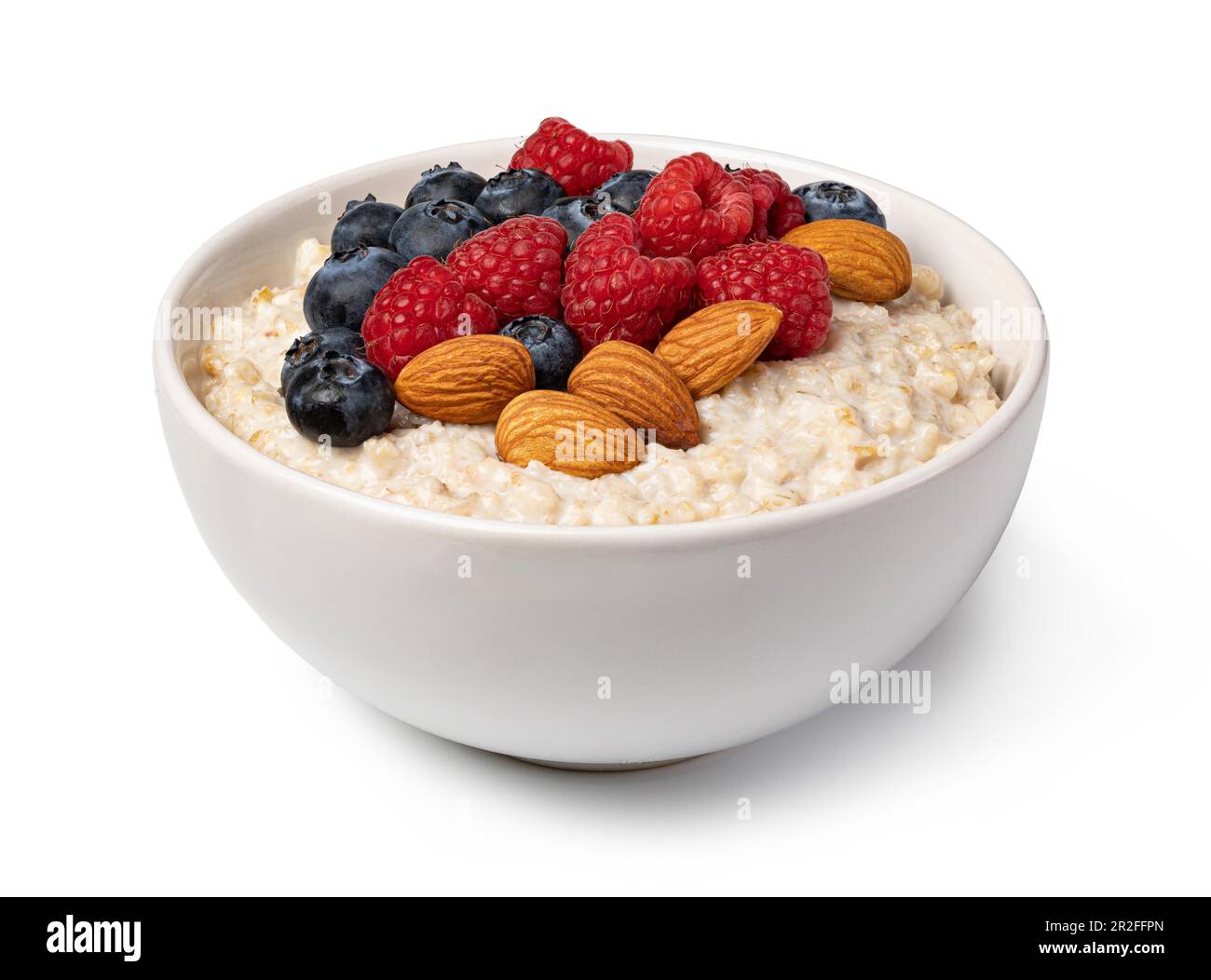 prepared oatmeal with berries and nuts isolated on white background ...