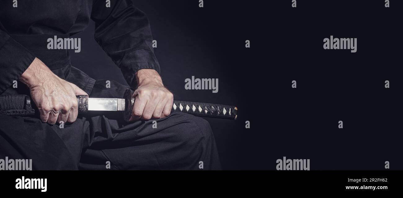 The samurai holding a Japanese katana sword, banner. Photo of a warrior ...