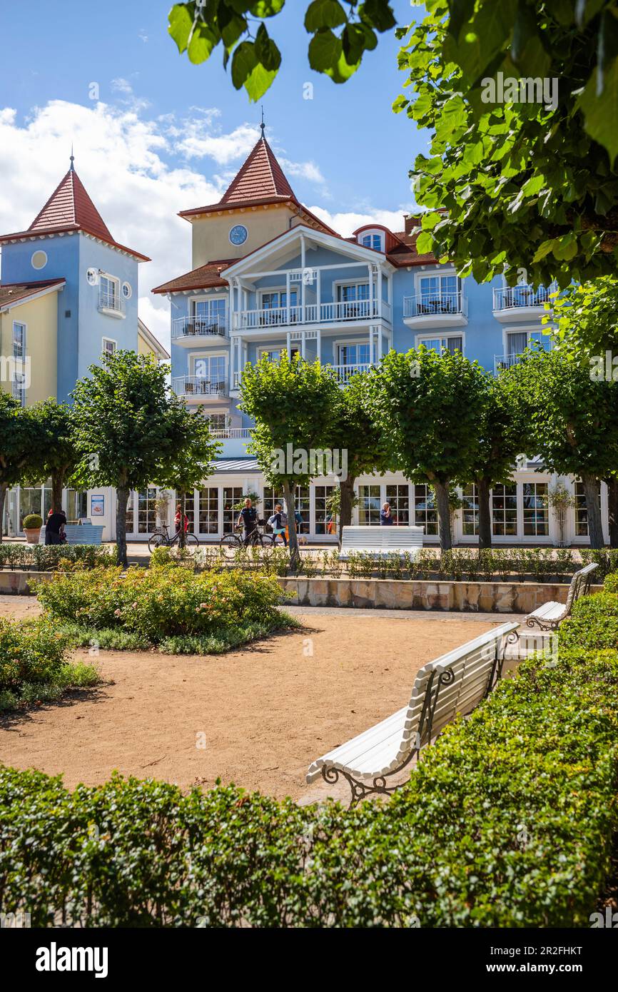 Park with benches in front of old villas on the beach promenade in ...