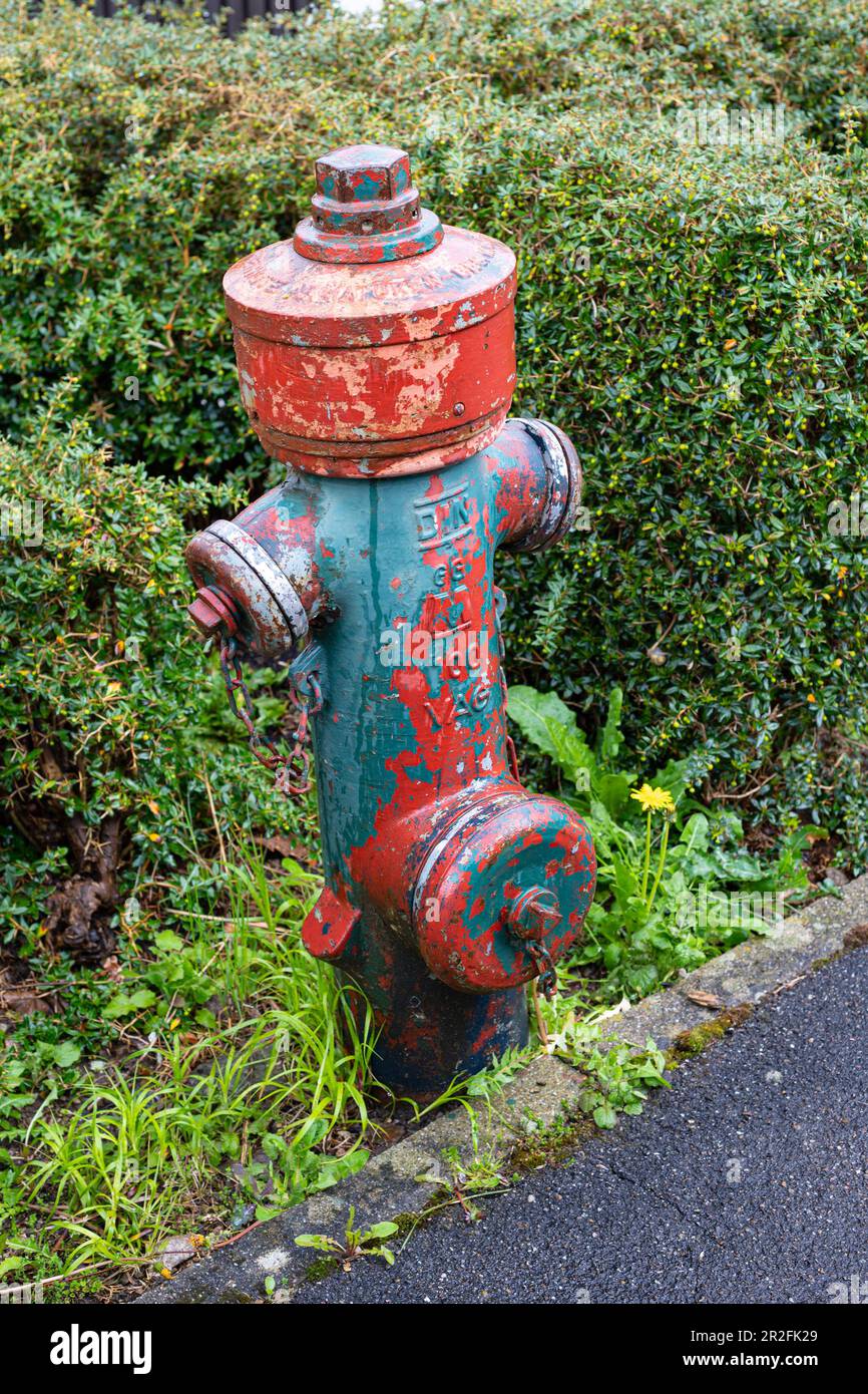 Red fire hydrant in a street in a german town Stock Photo - Alamy
