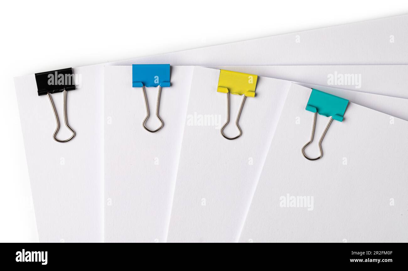 Multicolored paper clips on paperwork Stock Photo - Alamy