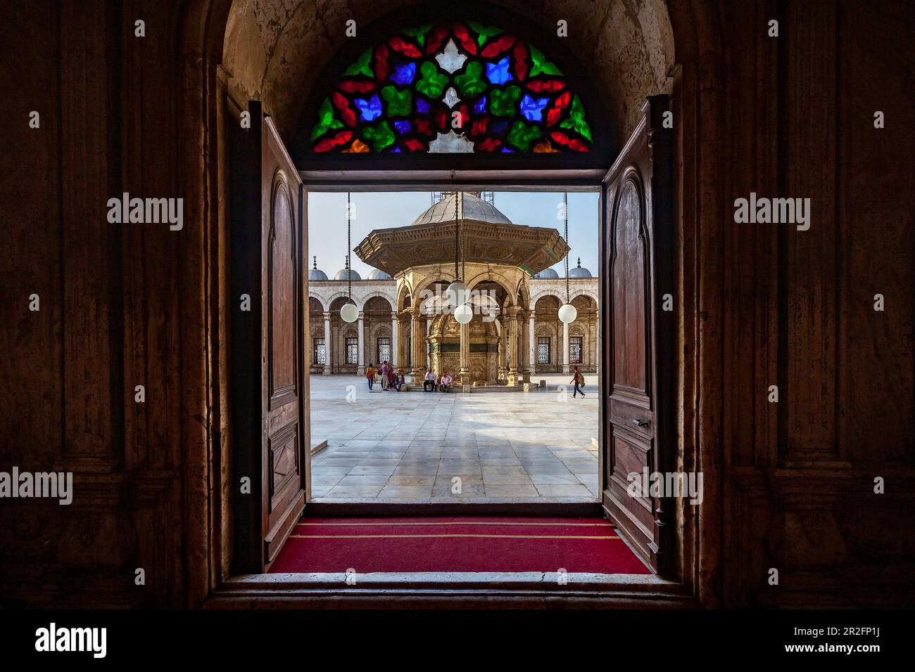 Doorway and stained glass window leading onto the courtyard of Great ...