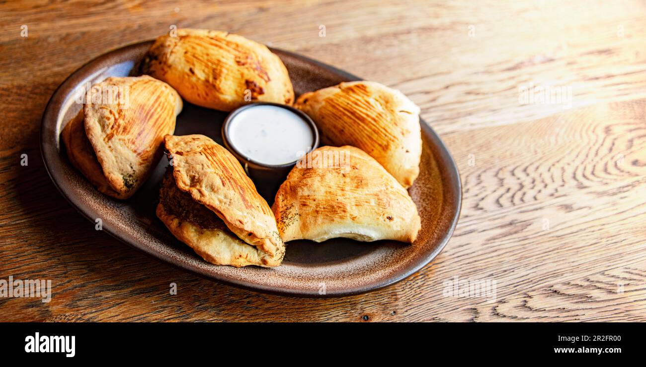 A plate of oven-baked pierogi on a restaurant table Stock Photo - Alamy