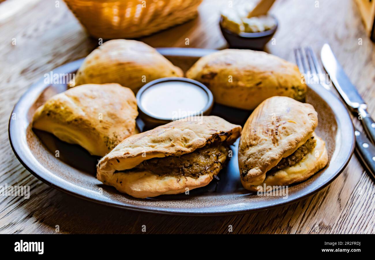 A plate of oven-baked pierogi on a restaurant table Stock Photo - Alamy