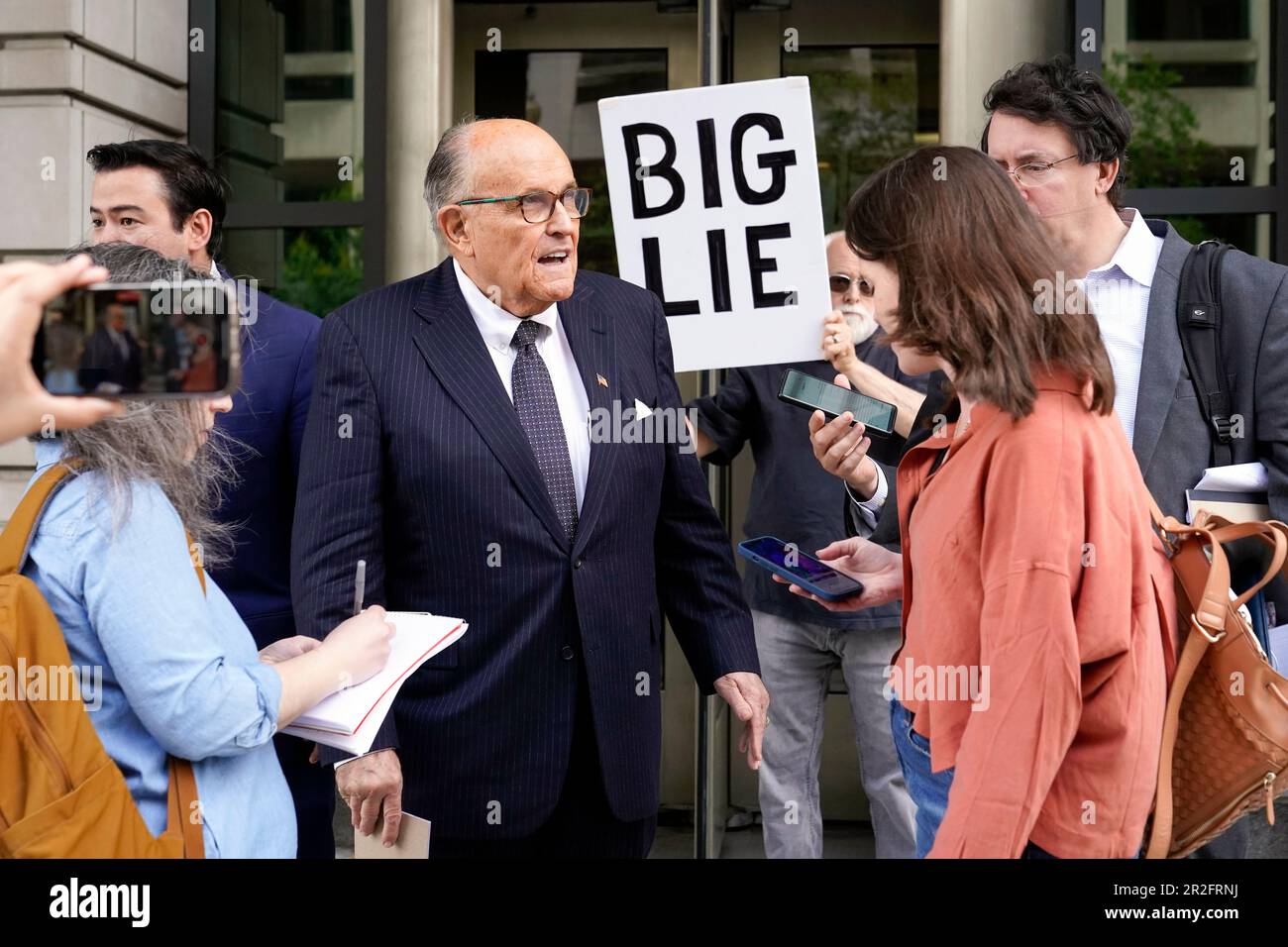 Rudy Giuliani speaks with reporters as he departs the federal ...
