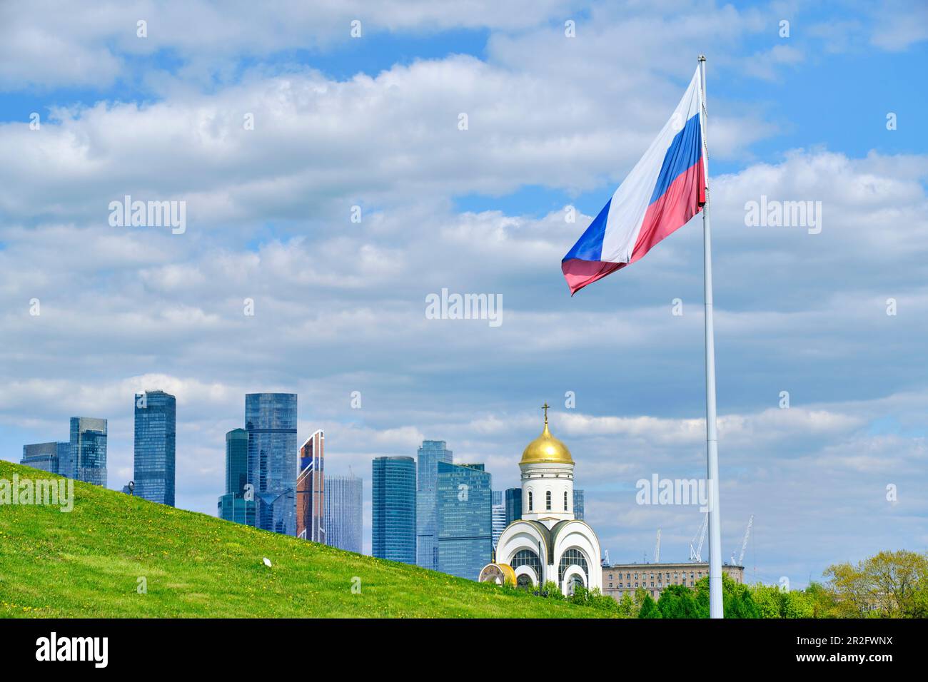 Developing flag Russia against background white church and modern ...