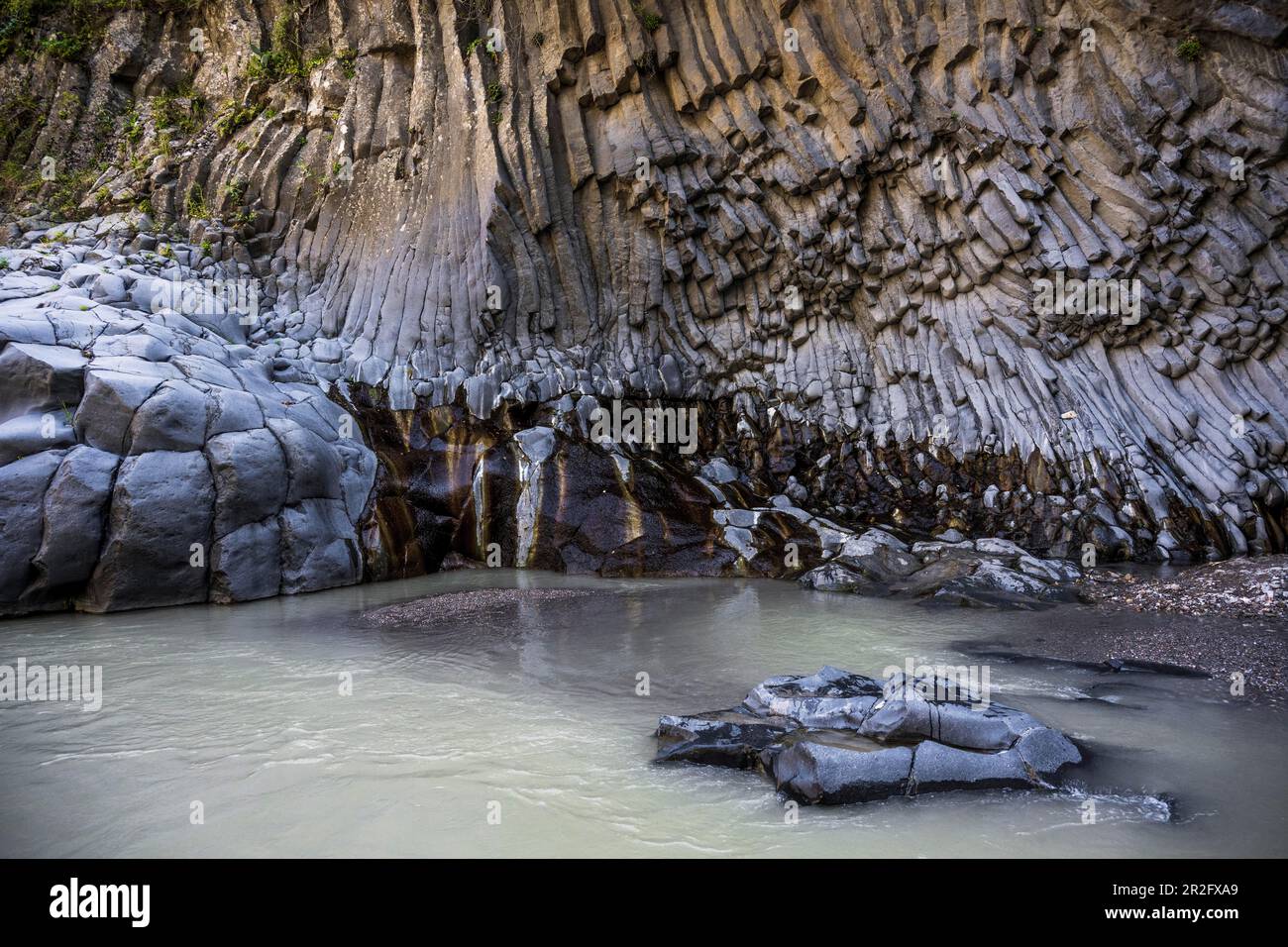 Rock formations of basalt and lava rock in the river park Gole dell ...