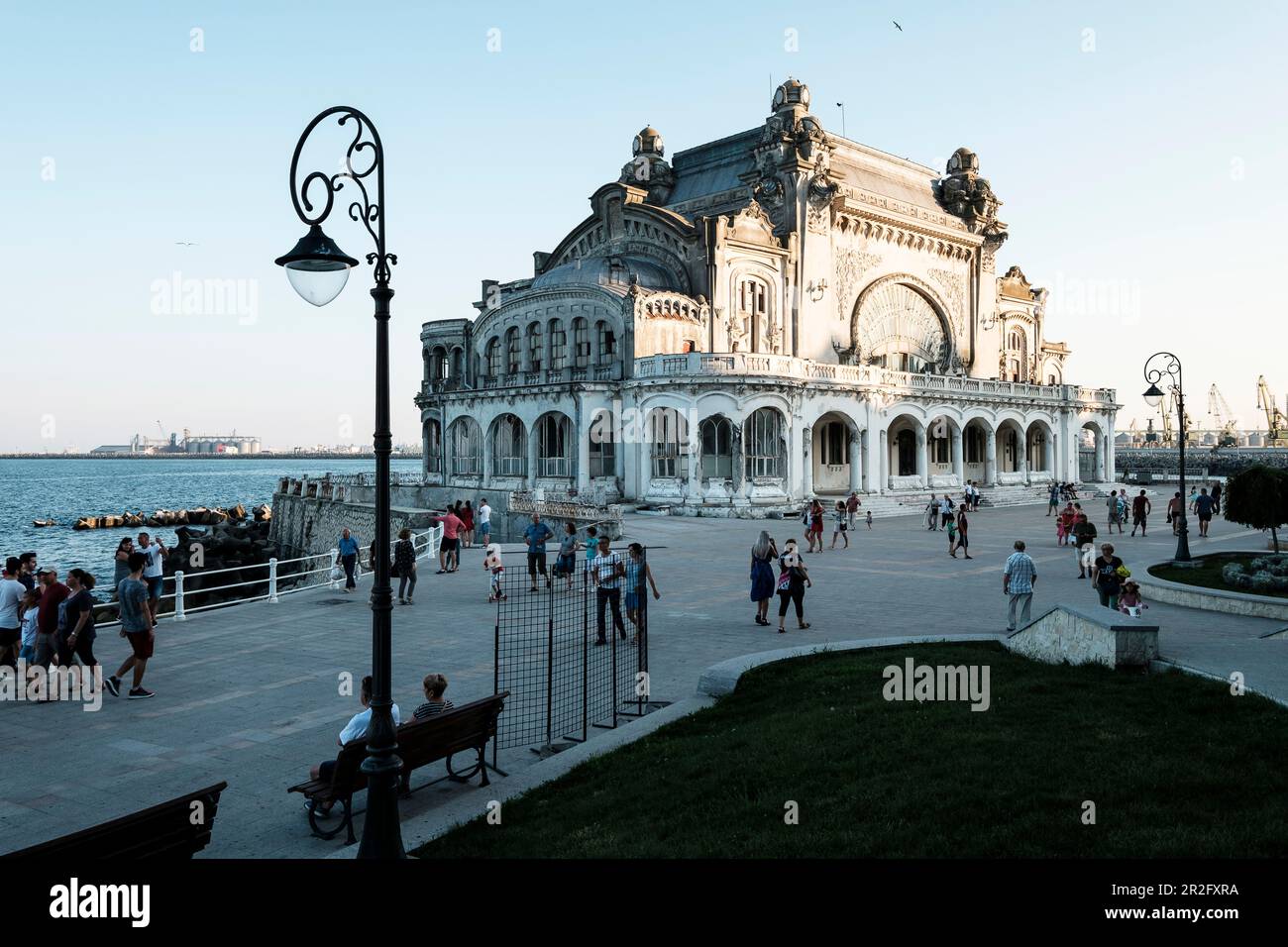 Passers-by stroll in front of the Old Casíno of Constanta on the Black ...