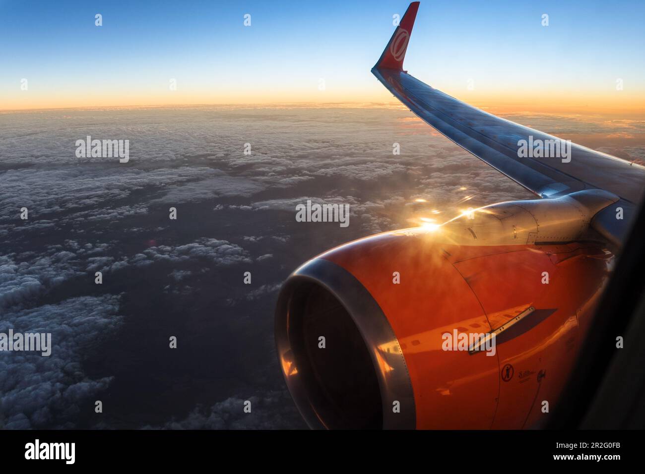View from the airplane window at sunrise, airplane wing Stock Photo - Alamy