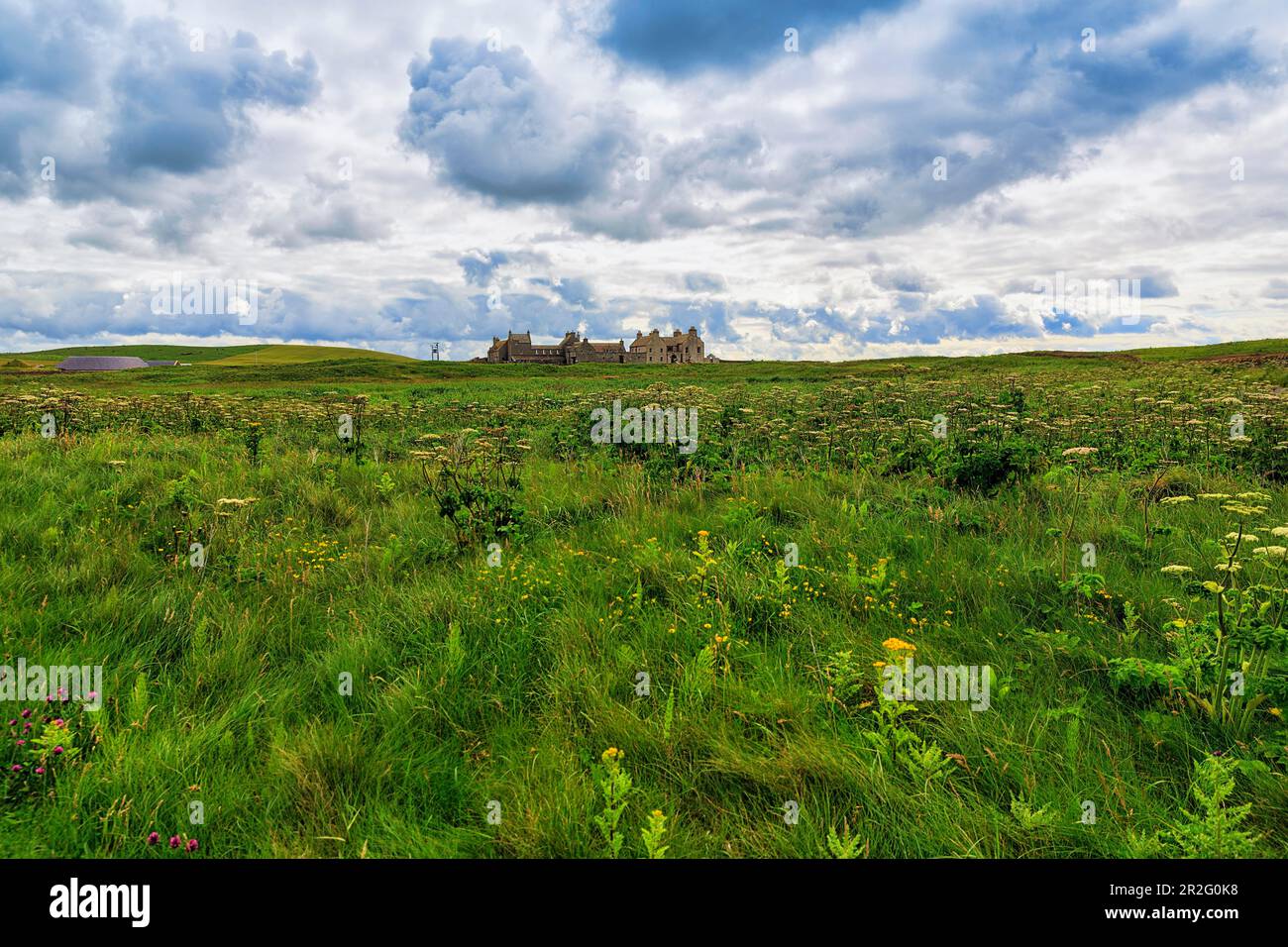 Cloudy sky over meadow, heritage-protected manor house, Skaill House on ...