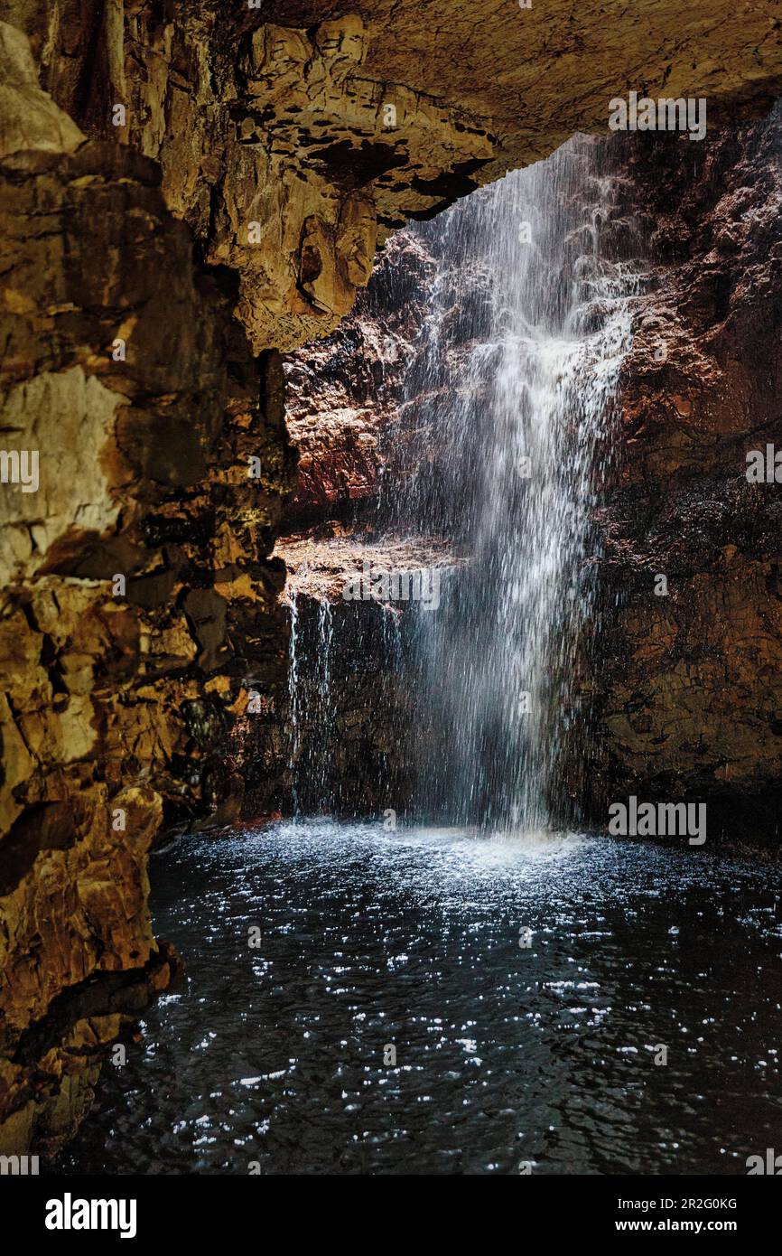 Waterfall, underground stream in limestone cave, Smoo Cave grotto ...