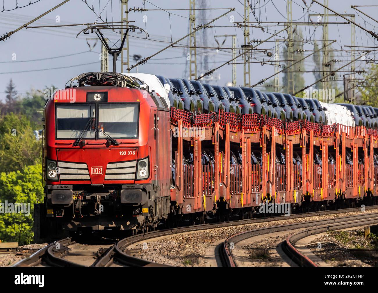 Goods train, loaded with new Mercedes cars, locomotive Siemens Vectron ...