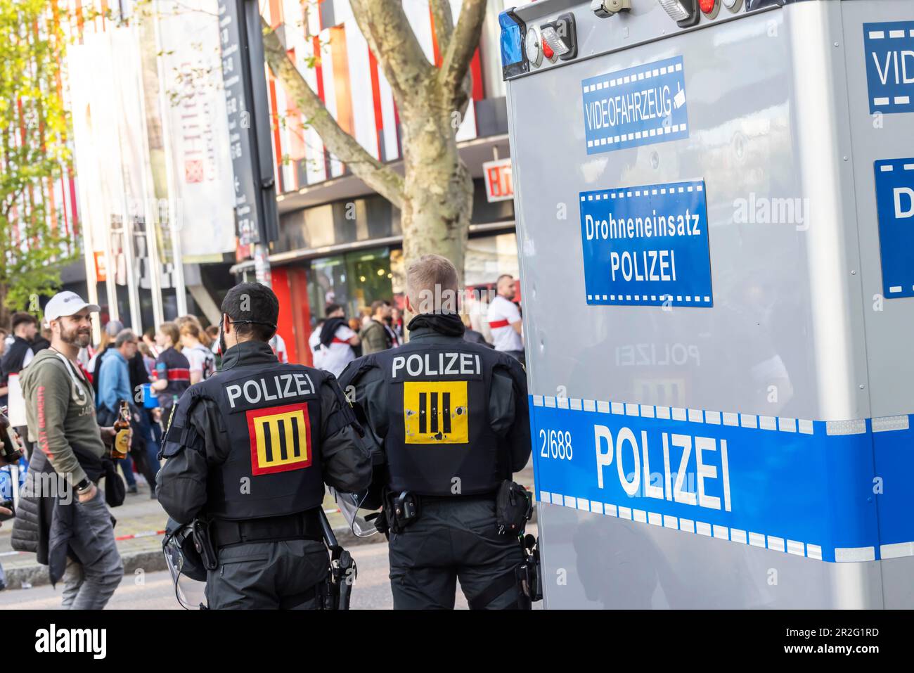 Police officers next to a vehicle labelled video vehicle, drone ...