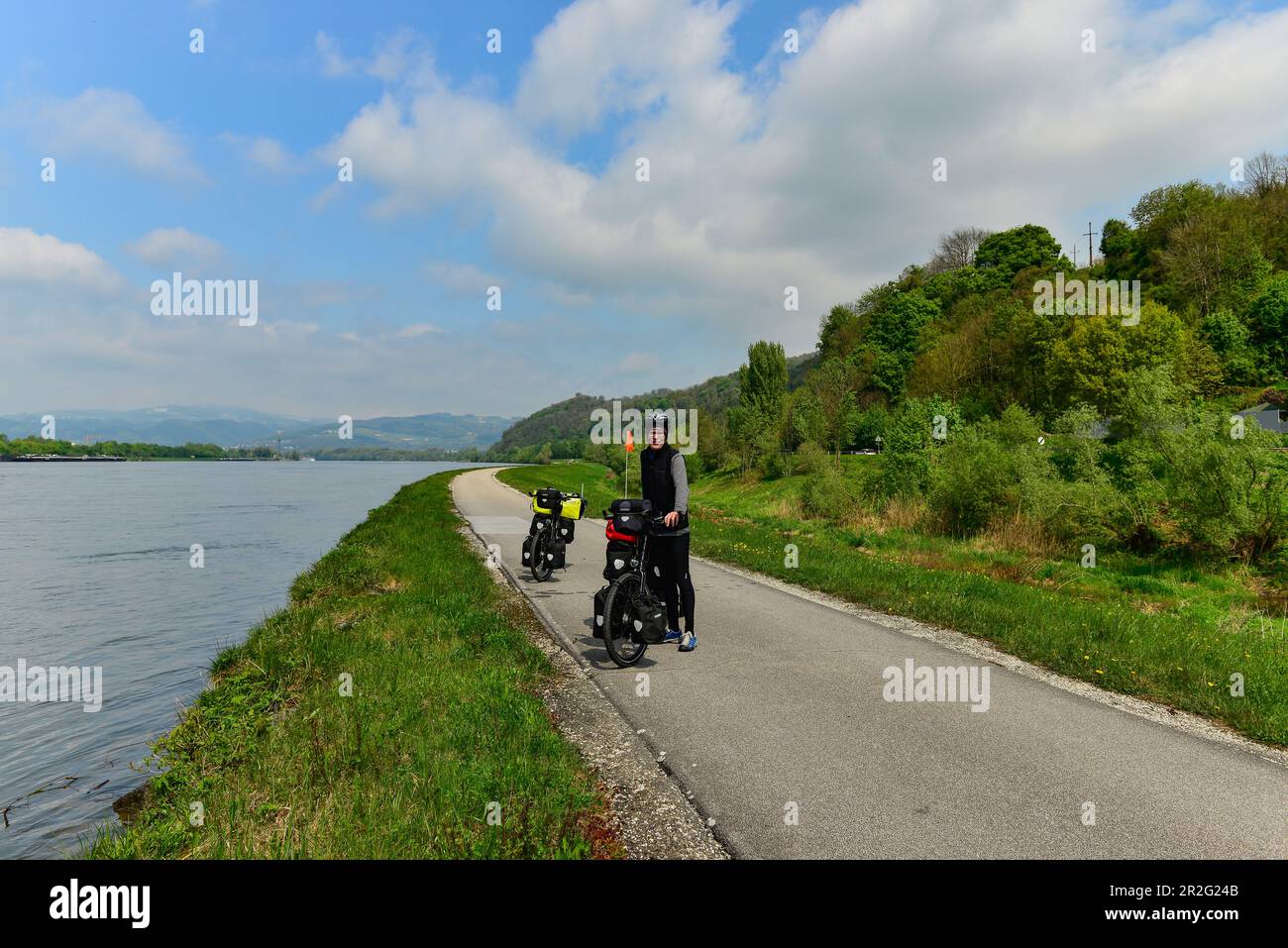 Cyclists with fully loaded bikes on a long tour on the Danube Cycle ...