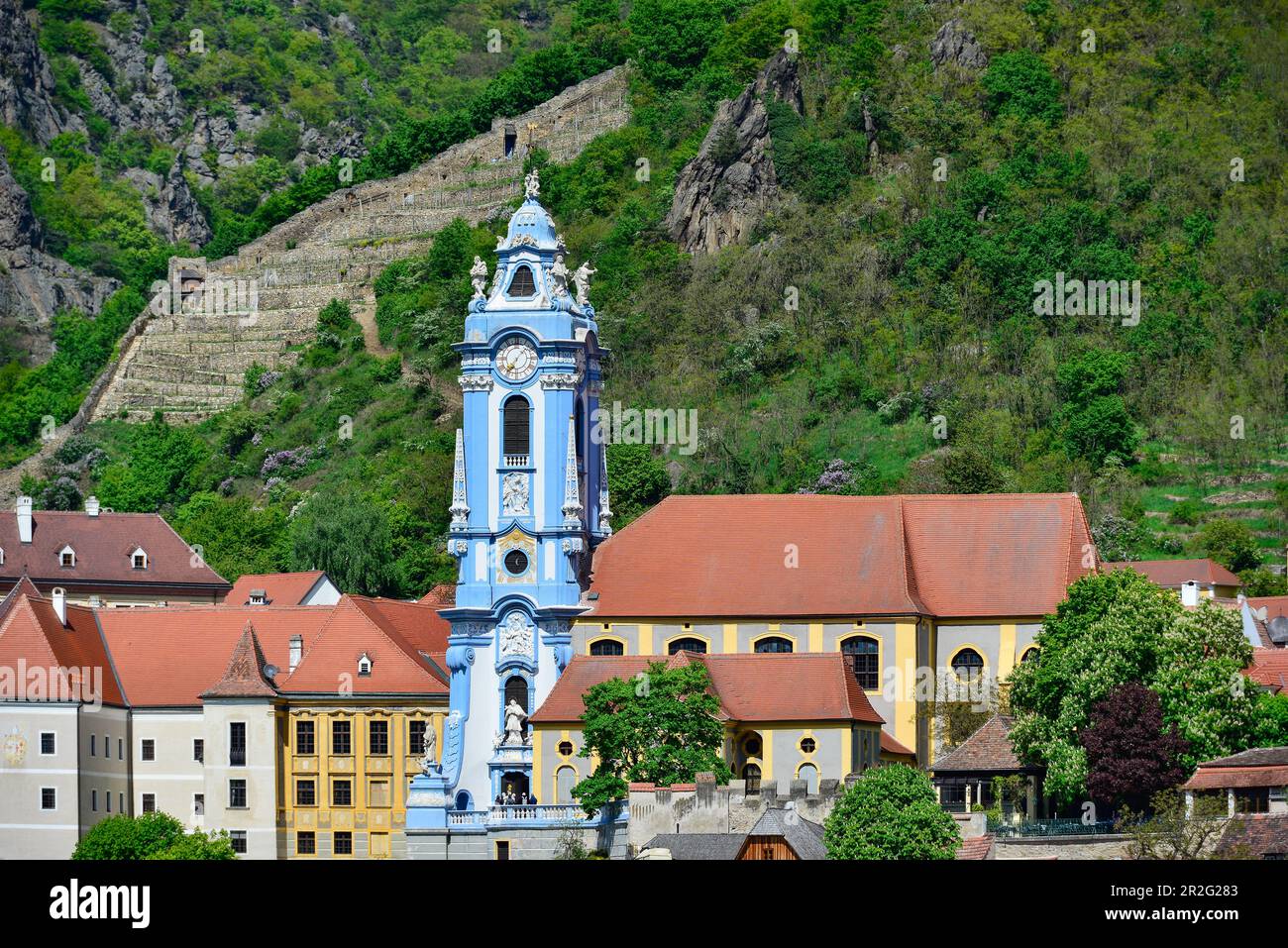 The blue church in front of the mountain slopes in Dürnstein an der ...
