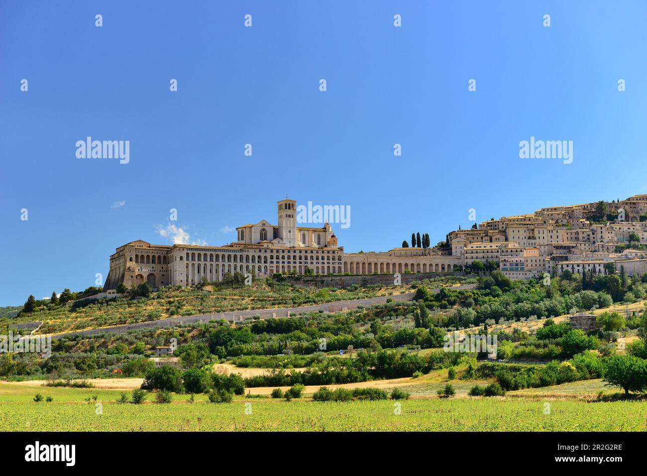 View of Assisi with old town and Basilica San Francesco and city walls ...