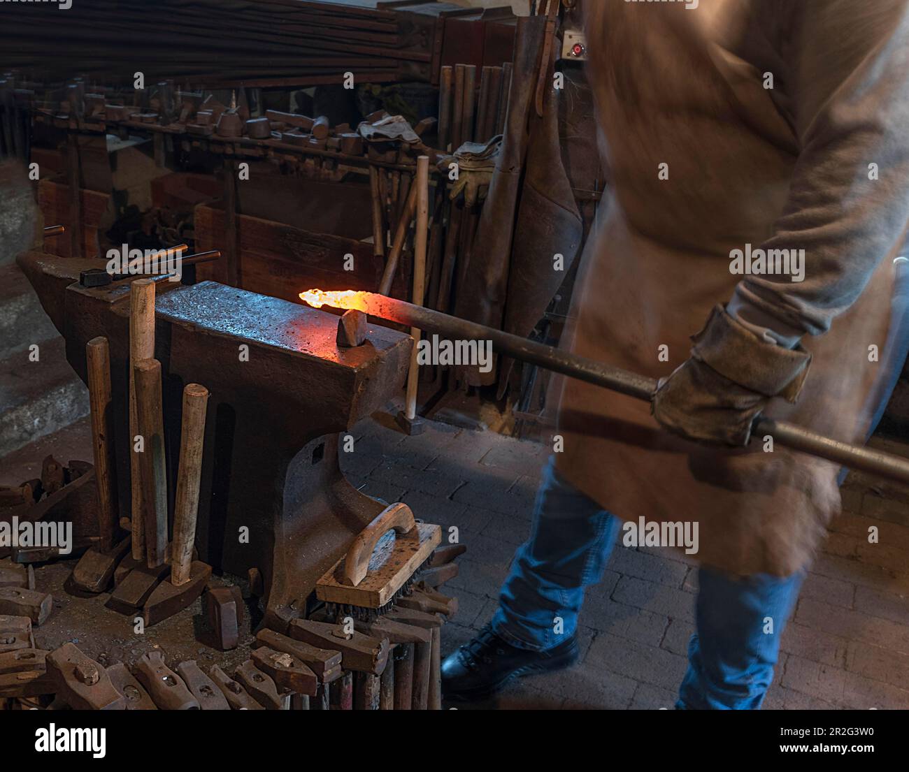 Iron is forged on an anvil, historic hammer mill, still in operation ...