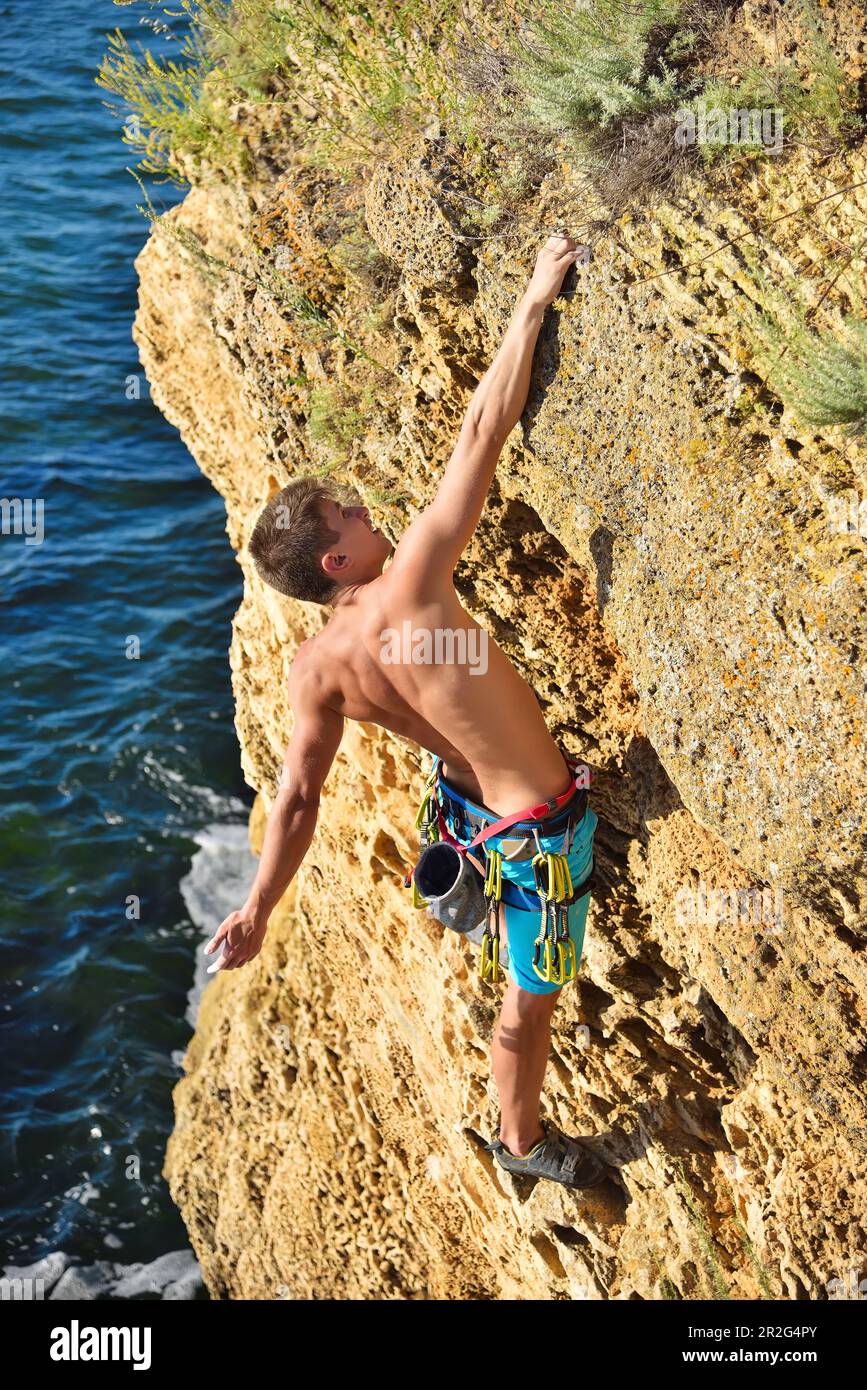 Man hanging on cliff hi-res stock photography and images - Alamy