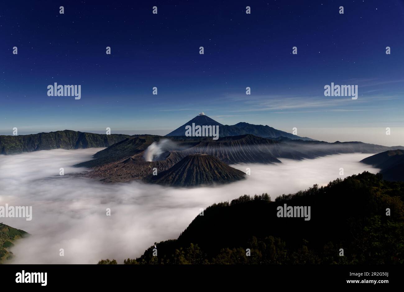 Fog cover over the Great Sand Sea, Bromo volcano and Semeru in the ...
