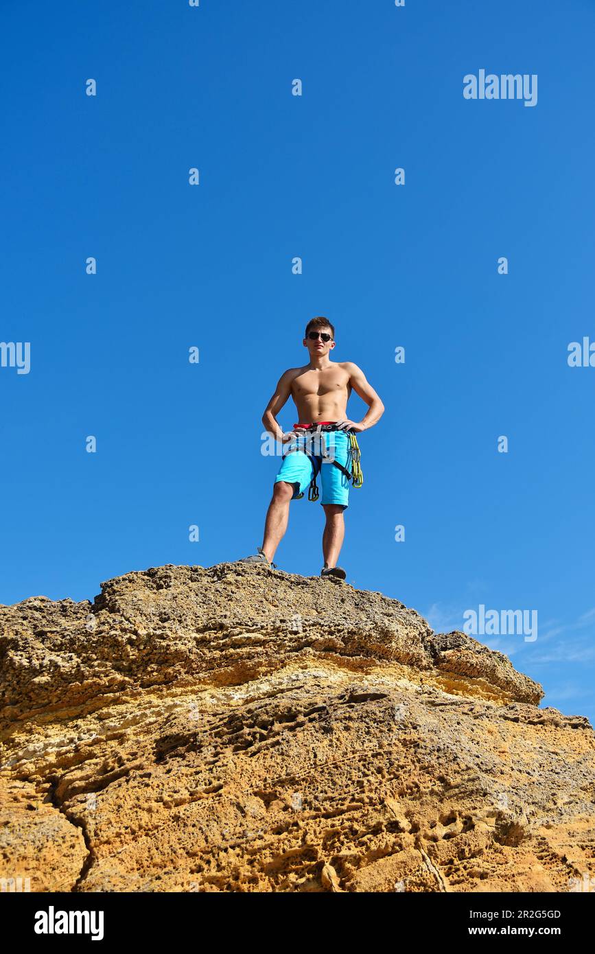 athletic climber man standing back on top mountain Stock Photo - Alamy