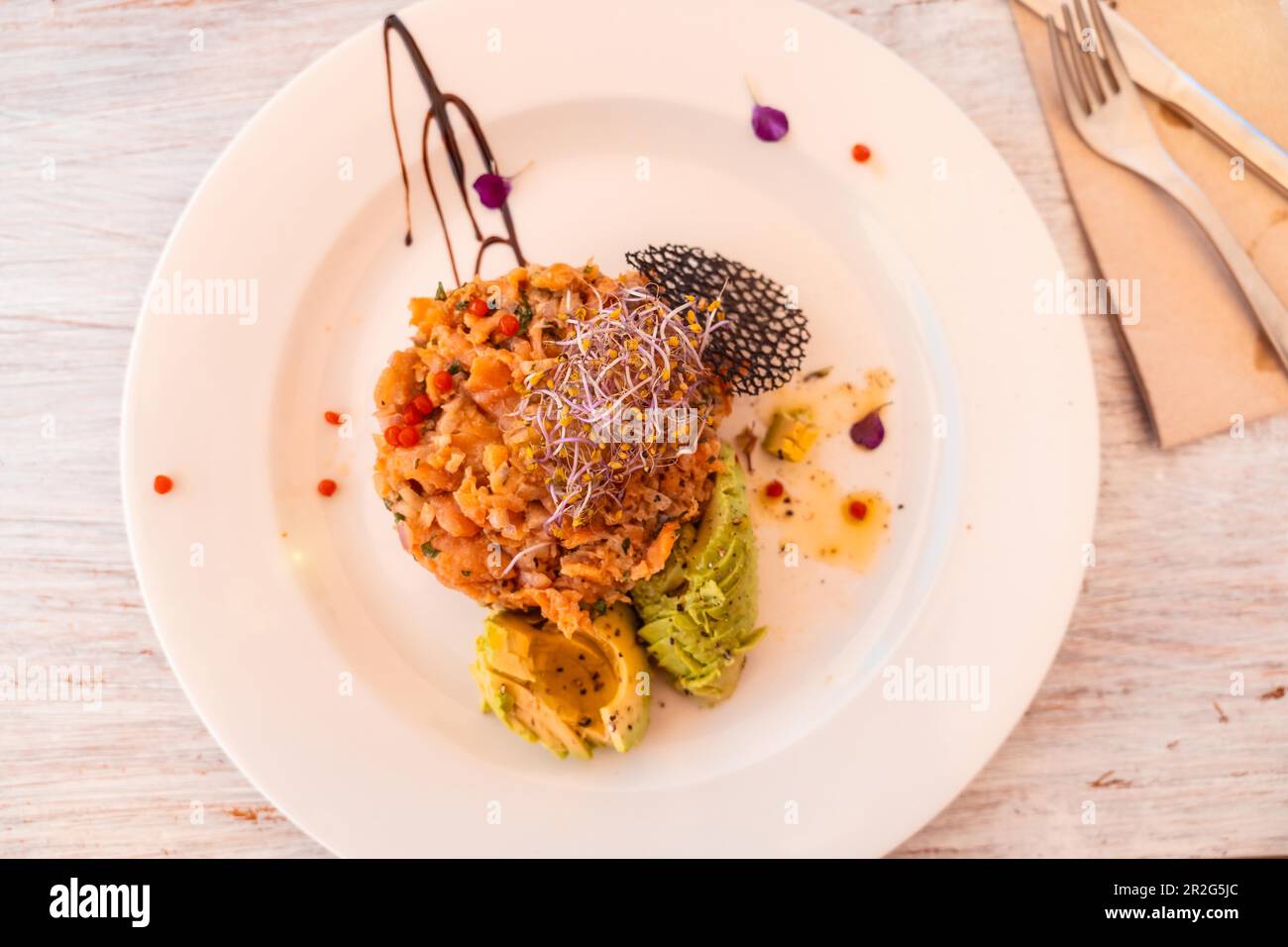 Detail with a female hand dining in a restaurant on the beach on ...