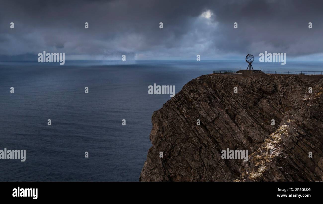 World globe at Nordkapp, Finnmark, Norway. Cliff, rain in the ...