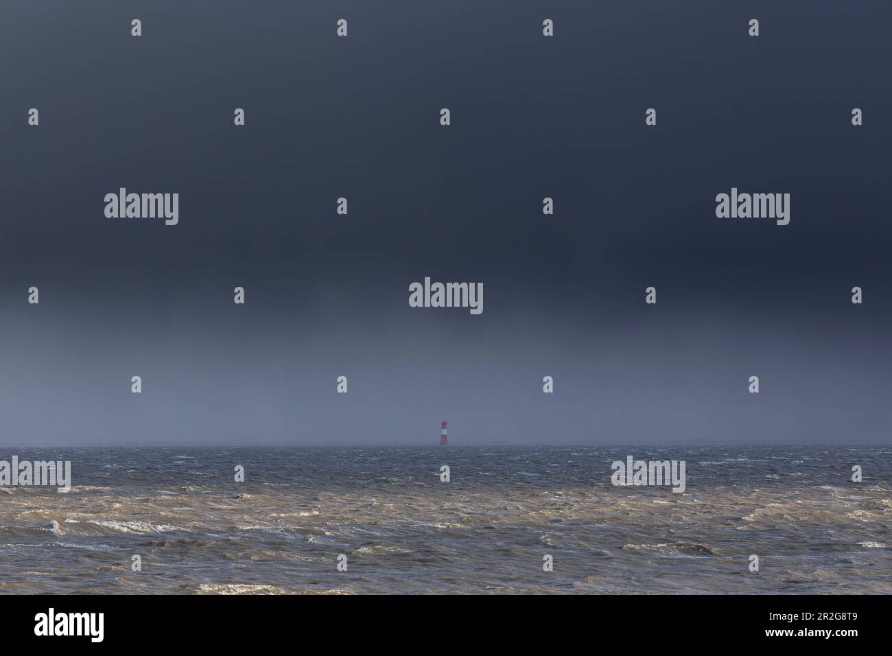 Sea-view. dark clouds. lighthouse in the distance. Wilhelmshaven, Jade ...