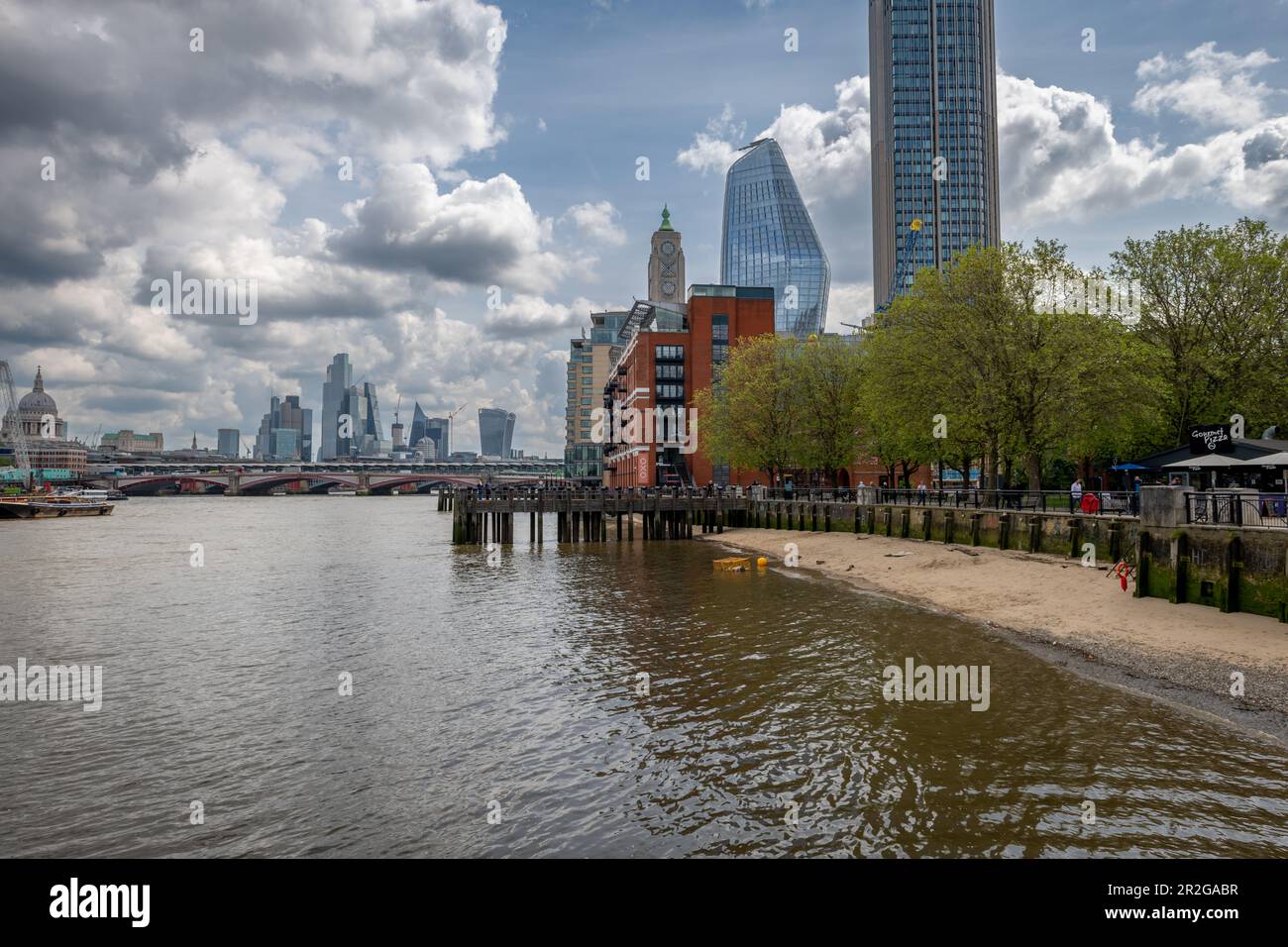 London. UK- 05.17.2023. General view of the Thames Beach. A sandy beach ...