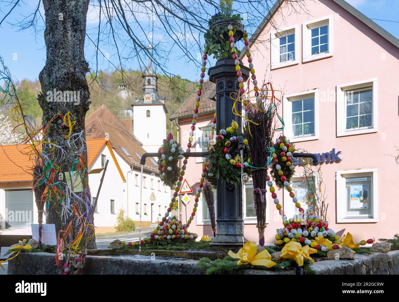 Easter fountain decorated with colorful Easter eggs and colored ribbons in Muggendorf in ...