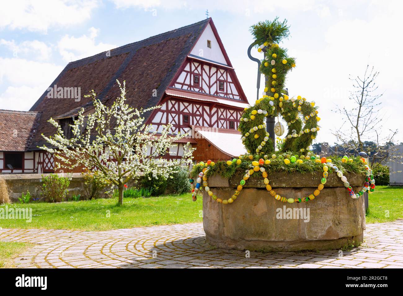 Easter fountain decorated with colorful Easter eggs in the churchyard ...
