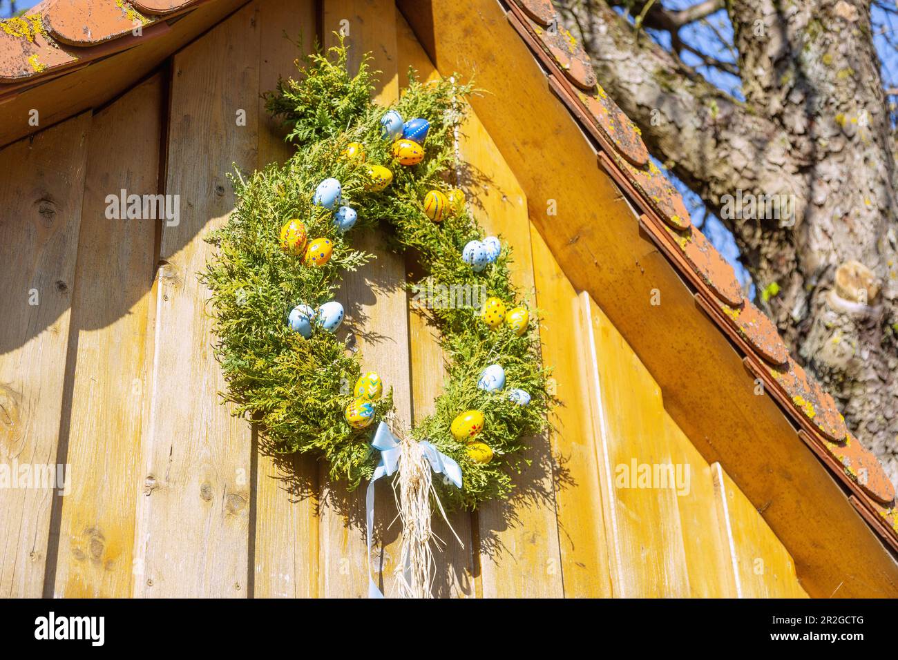 Easter wreath, Easter fountain decorated with colorful Easter eggs in ...