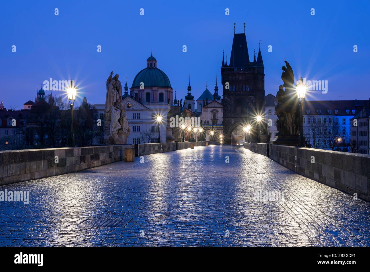 Charles Bridge with Old Town Bridge Tower, Church of the Cross, dawn, Prague, Czech Republic ...