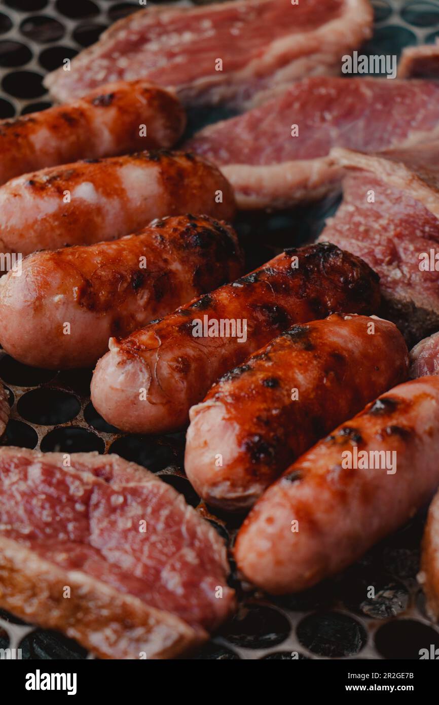 assorted meats smoking on the barbecue Stock Photo - Alamy