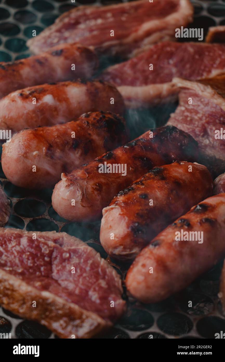 different meats smoking on the barbecue Stock Photo - Alamy