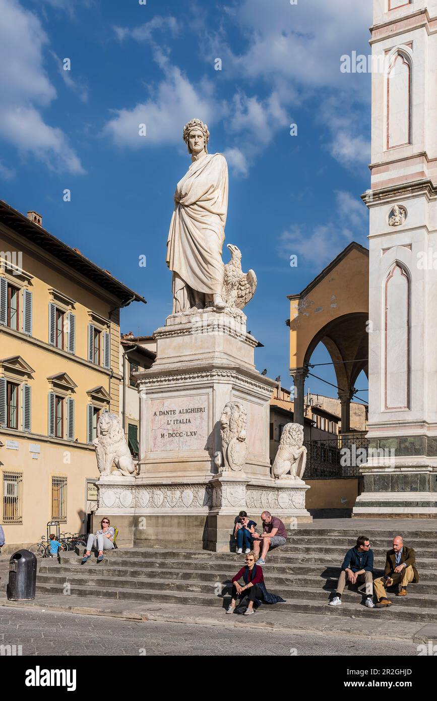 Statue of Dante Alighieri, people with bicycles in front of facade of ...
