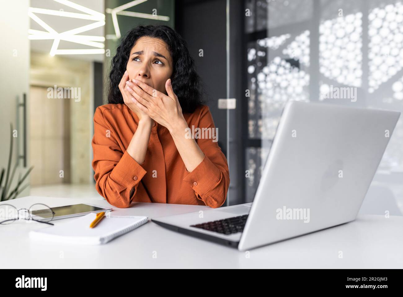 Boring and boring job business woman yawning at workplace, latin ...